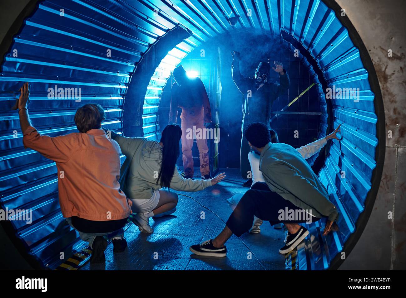 scary people in gas masks walking around smoke near group of people ...