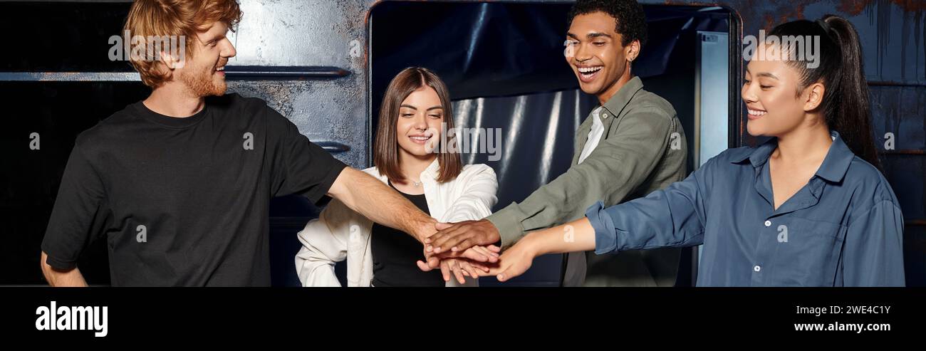 Diverse group smiling stacking hands hi-res stock photography and ...