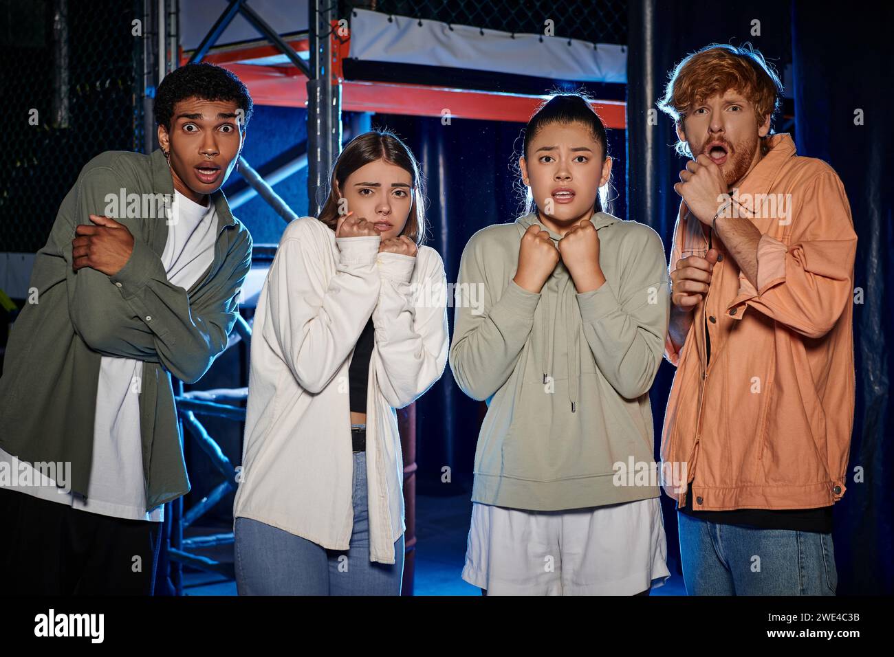 group of diverse and astonished young people looking at camera and ...
