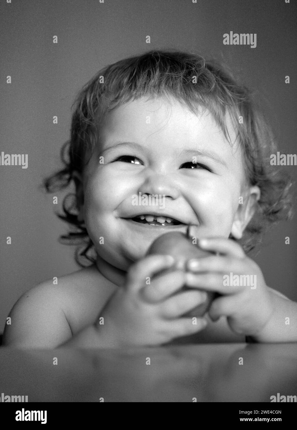 Smiling happy baby with apples. Enjoy eating moment. Healthy food and ...