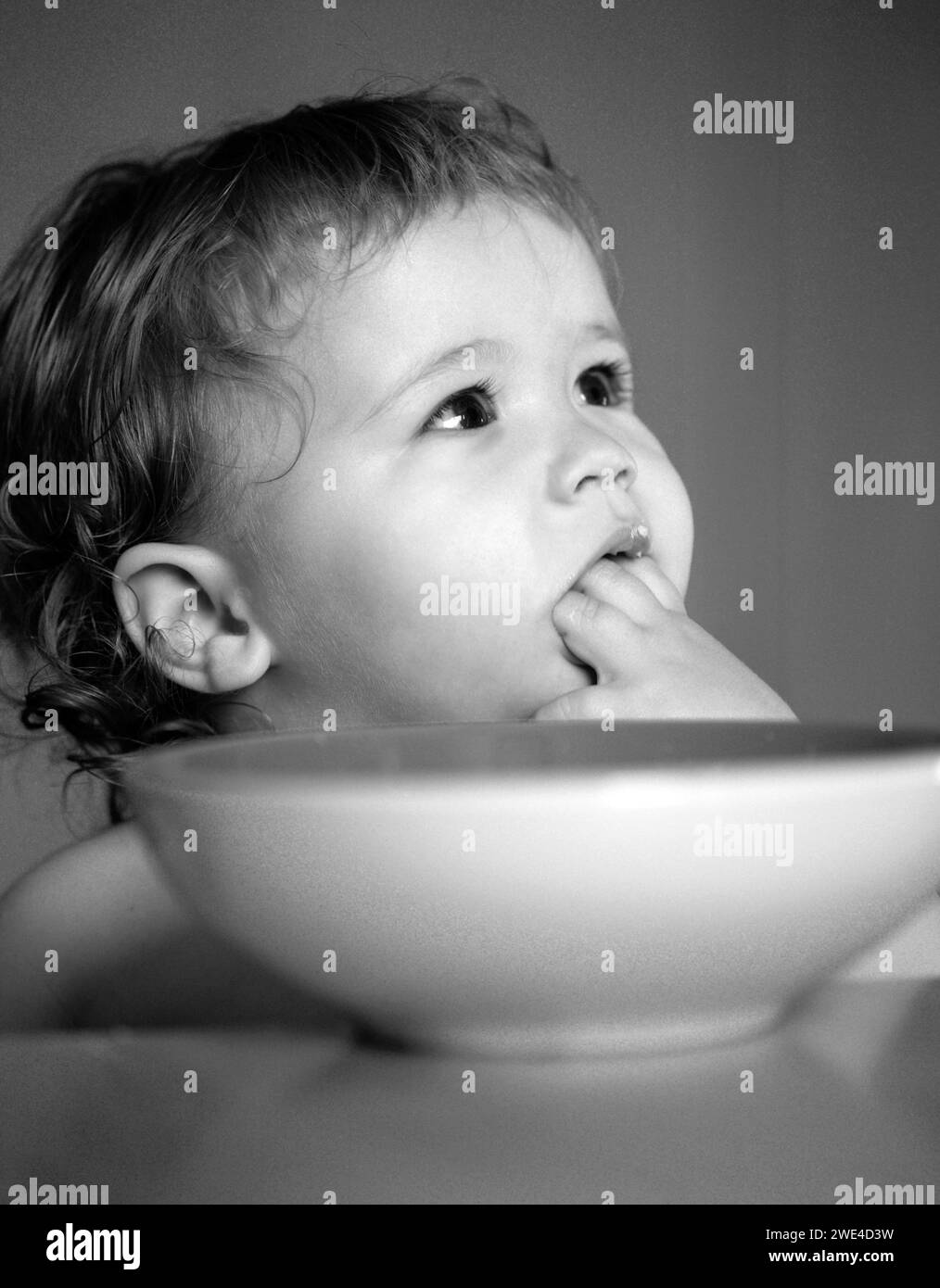 Kid baby eat soup in the kitchen with dishes and spoon Stock Photo - Alamy