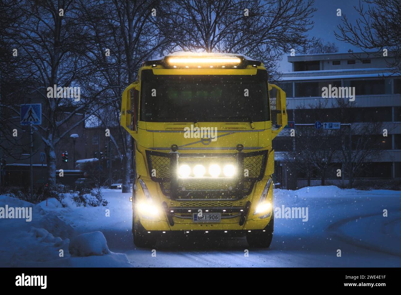 Brilliant headlights and auxiliary lights of a new yellow Volvo FH ...