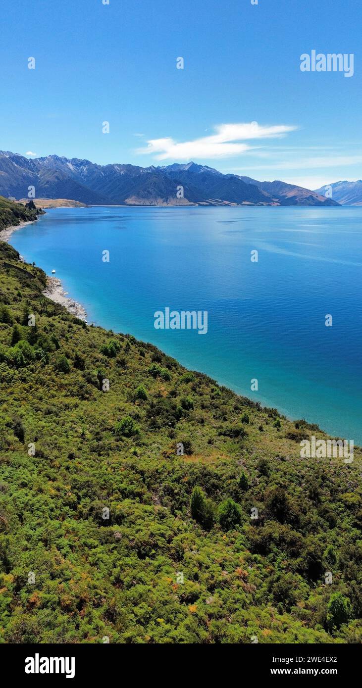 An aerial view of Lake Hawea surrounded by lush greenery. New Zealand ...