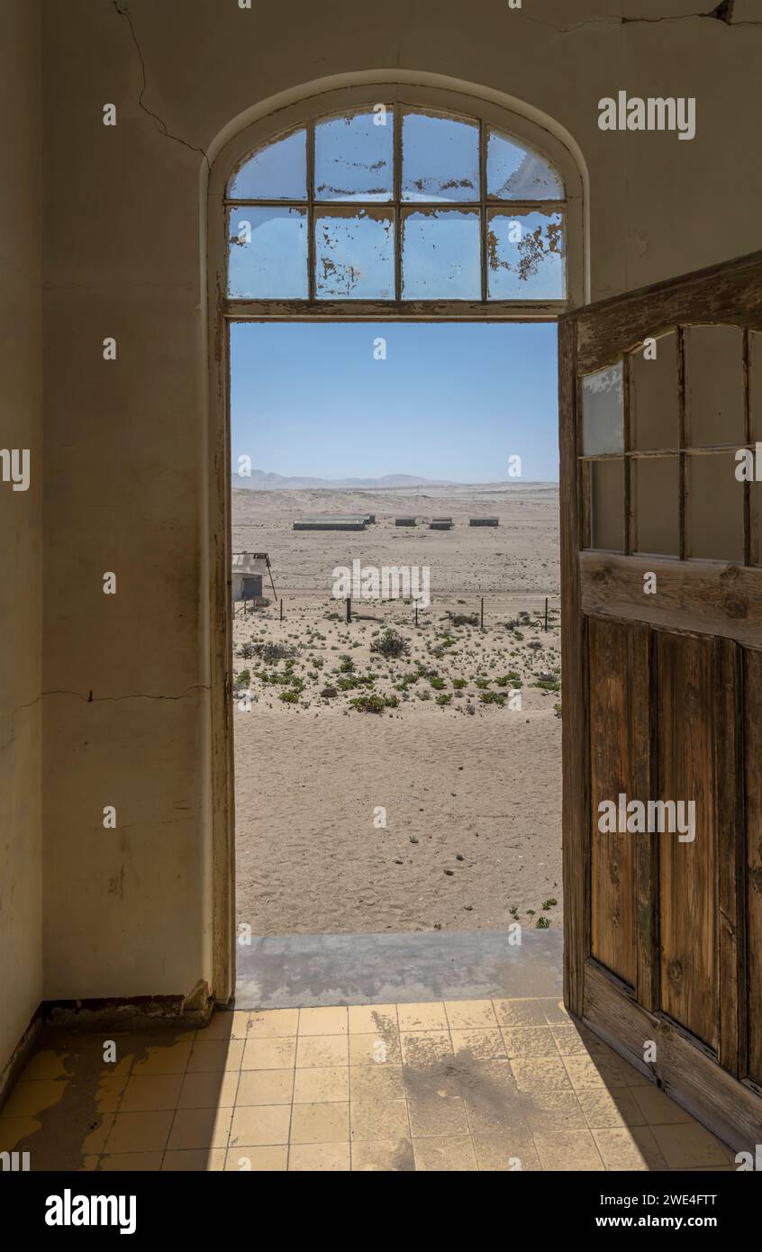 desert landscape through forsaken hospital building door at mining ...