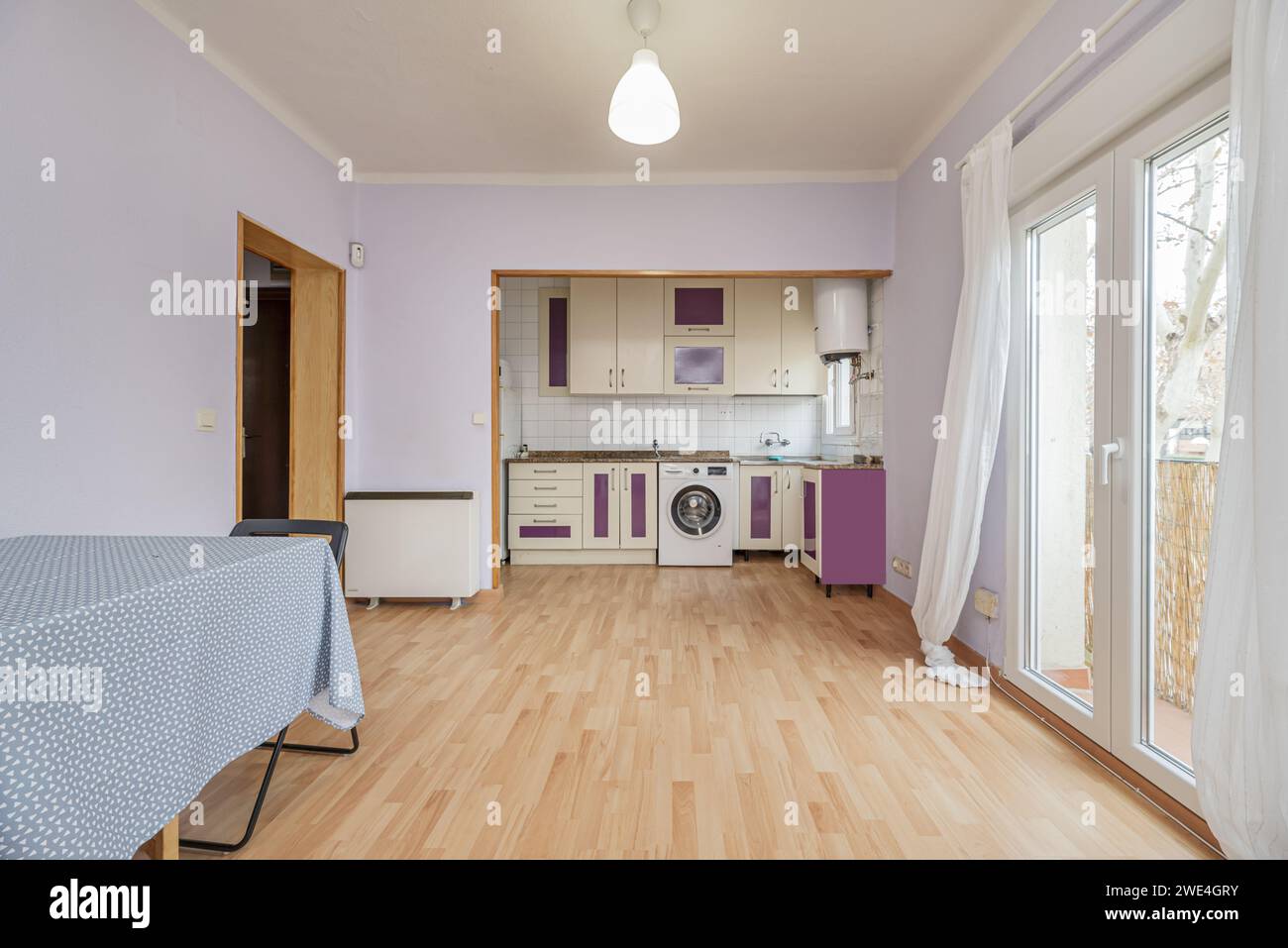 Small open kitchen in a loft-style apartment with various shades of ...