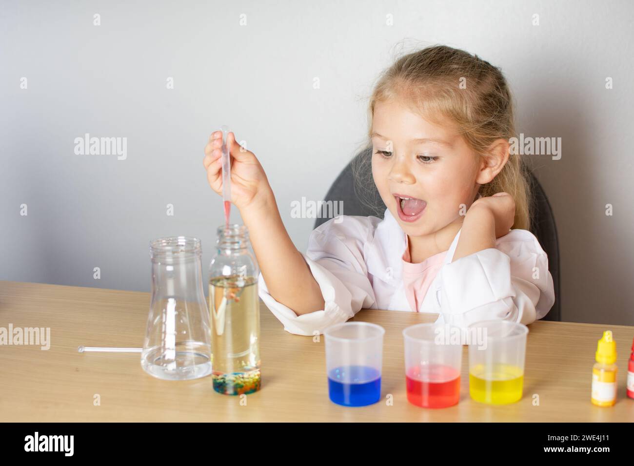 Little girl doing science experiment. Kindergarten. Education concept ...