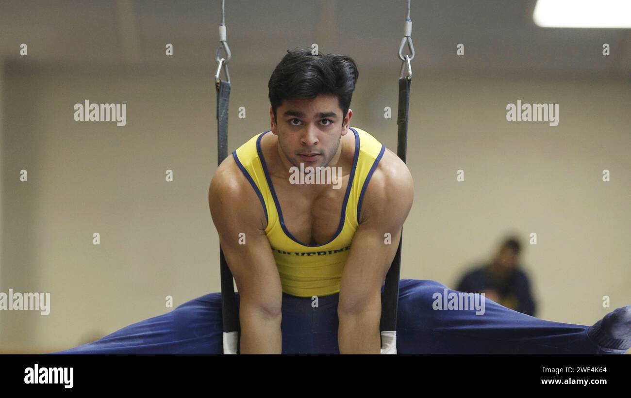 Michigan's Rithik Puri competes on the rings during an NCAA gymnastics ...