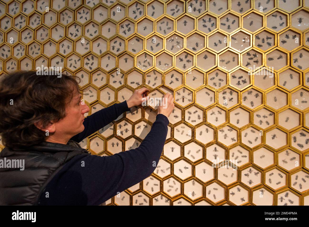 London, UK. 23 January 2024. Artist Tom Rooth with his work 'Honeycomb ...