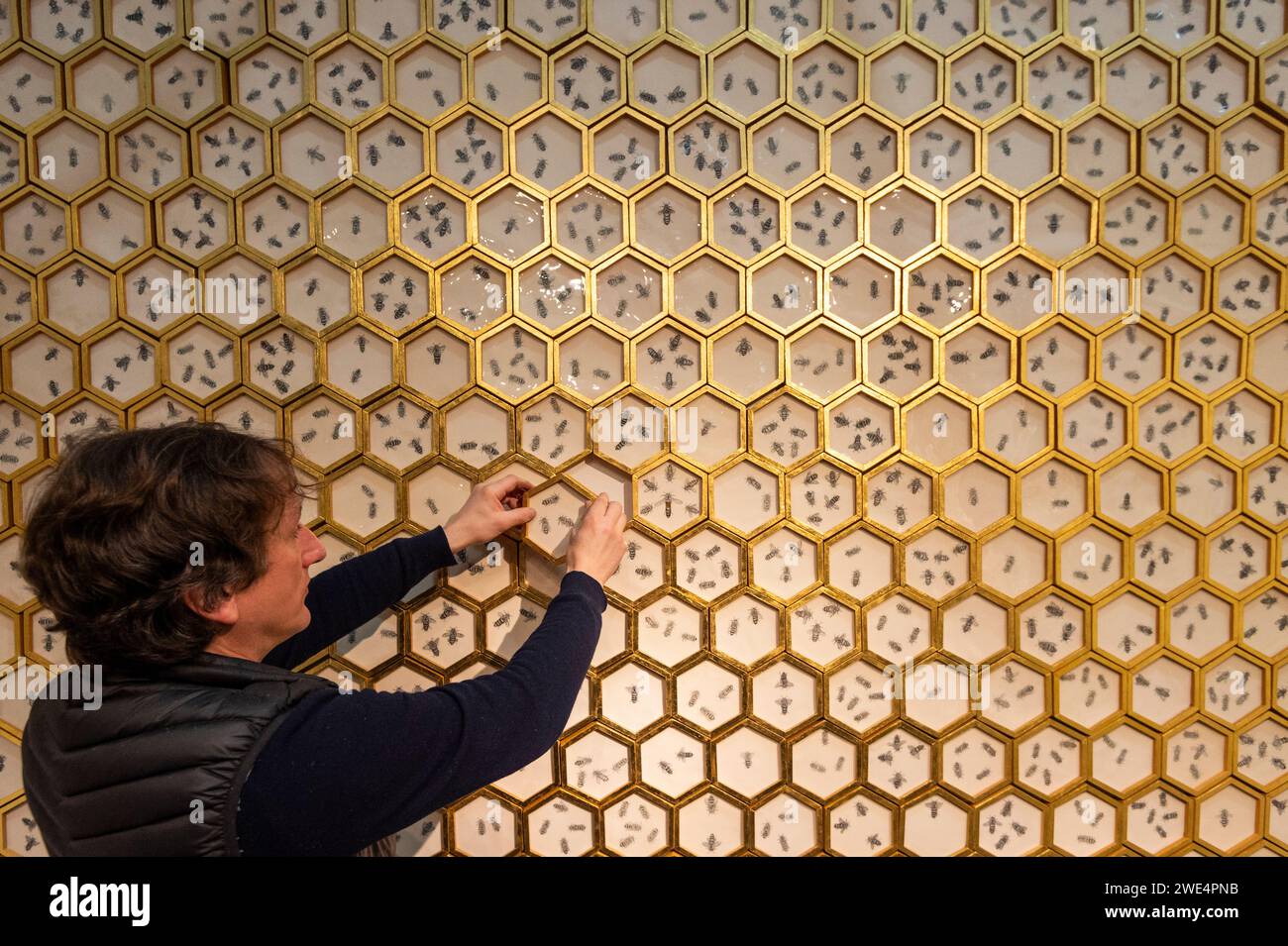 London, UK. 23 January 2024. Artist Tom Rooth with his work 'Honeycomb ...
