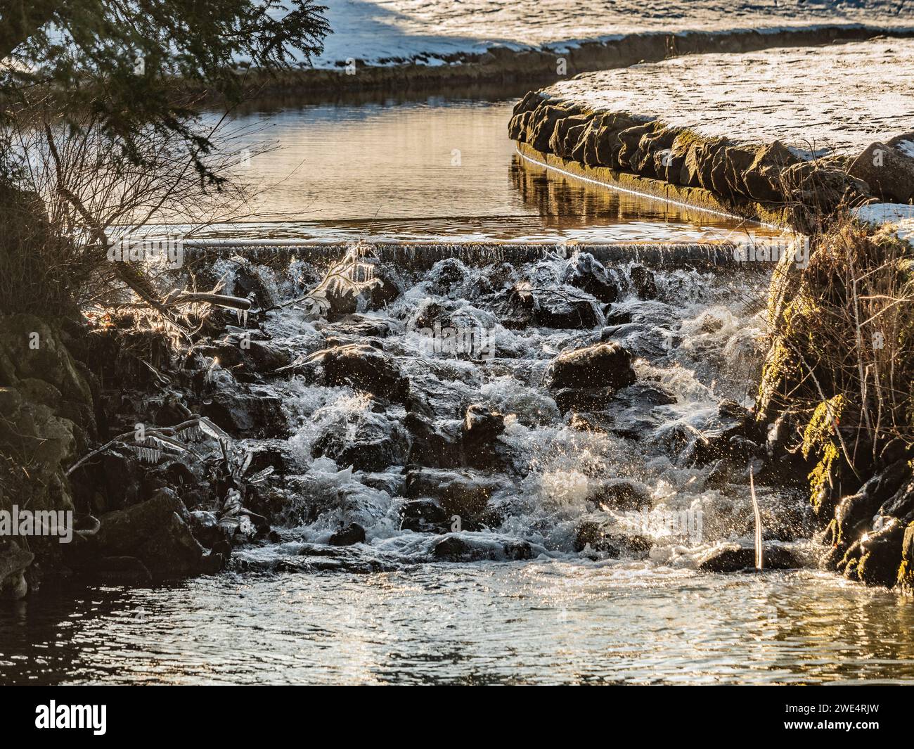 Frozen water. River Wye waterfall in Pavilion Park in Buxton ...