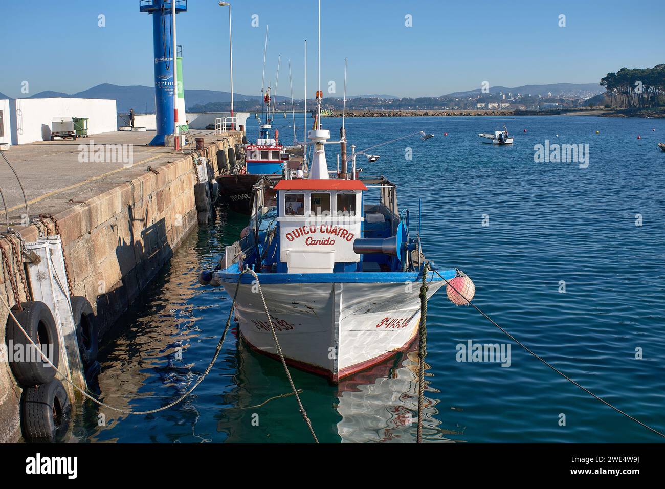 Small inshore boats dock in the small port of Canido to unload fish for ...