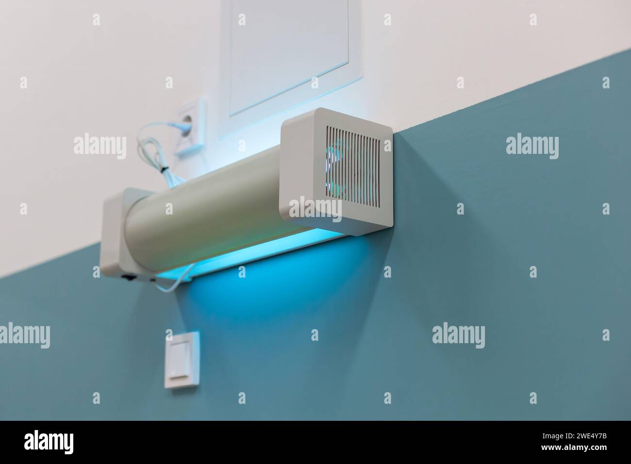 Wall-mounted UV sterilization lamp emitting blue light for disinfection ...