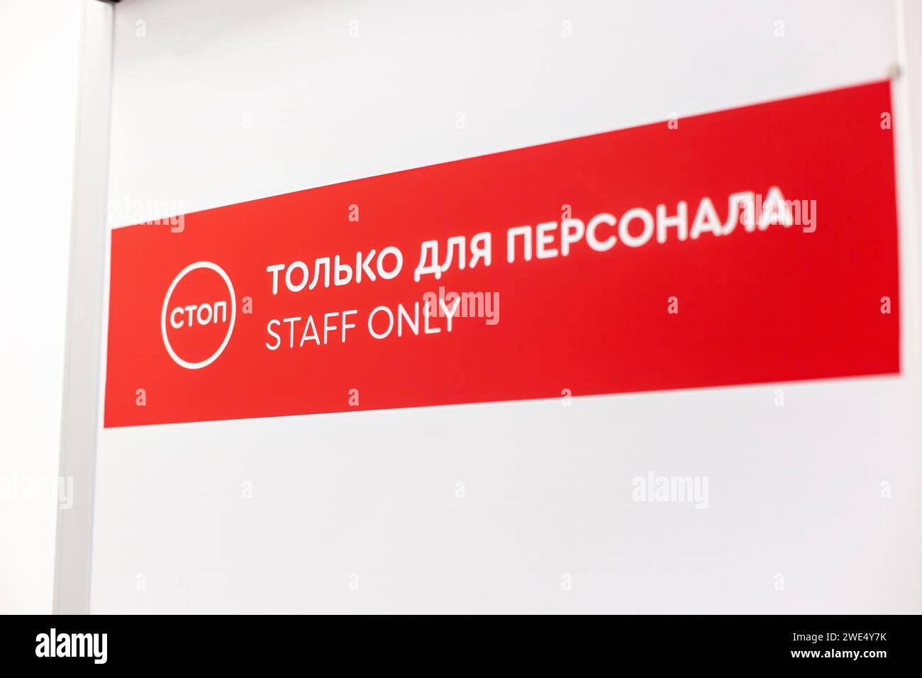 Red and white 'Staff Only' sign with bilingual text in English and ...