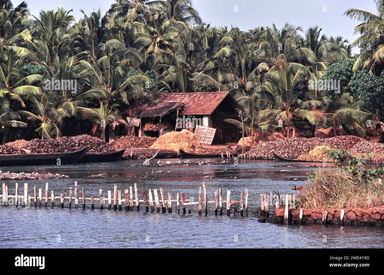 Coir production Kerala India factory shed with heaps of orange coir ...