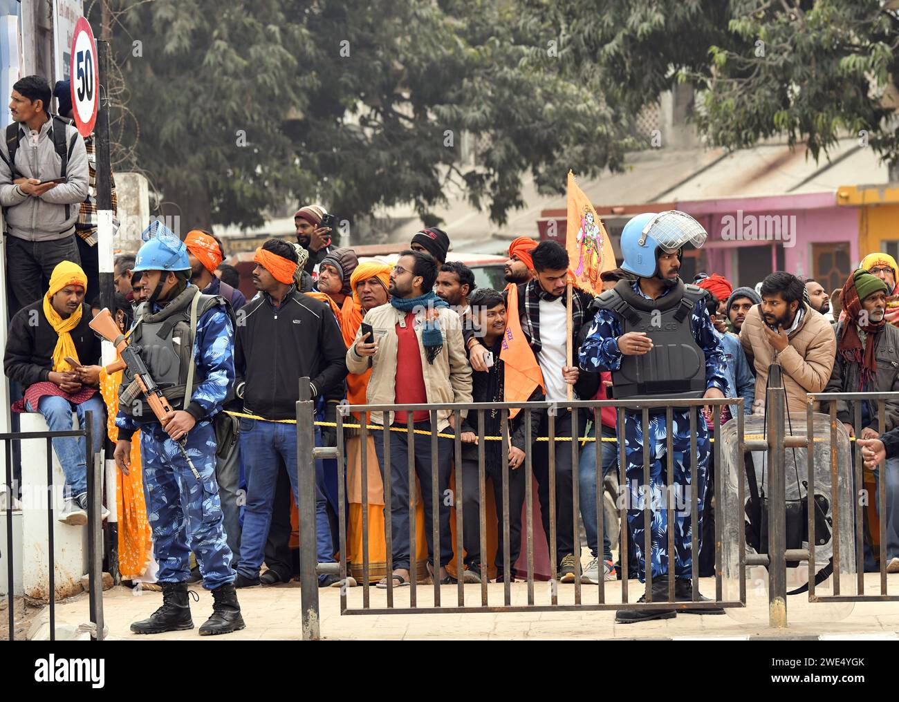 Ayodhya. Jan 22 (ANI): Security personnel stand guard as devotees stand ...