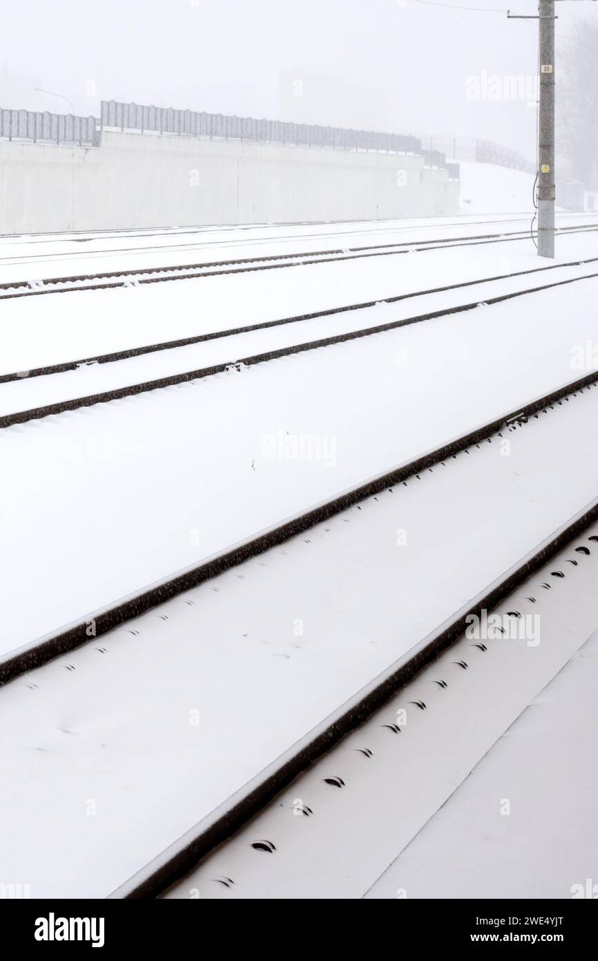 Train rails in the snow in a snowstorm close up Stock Photo - Alamy