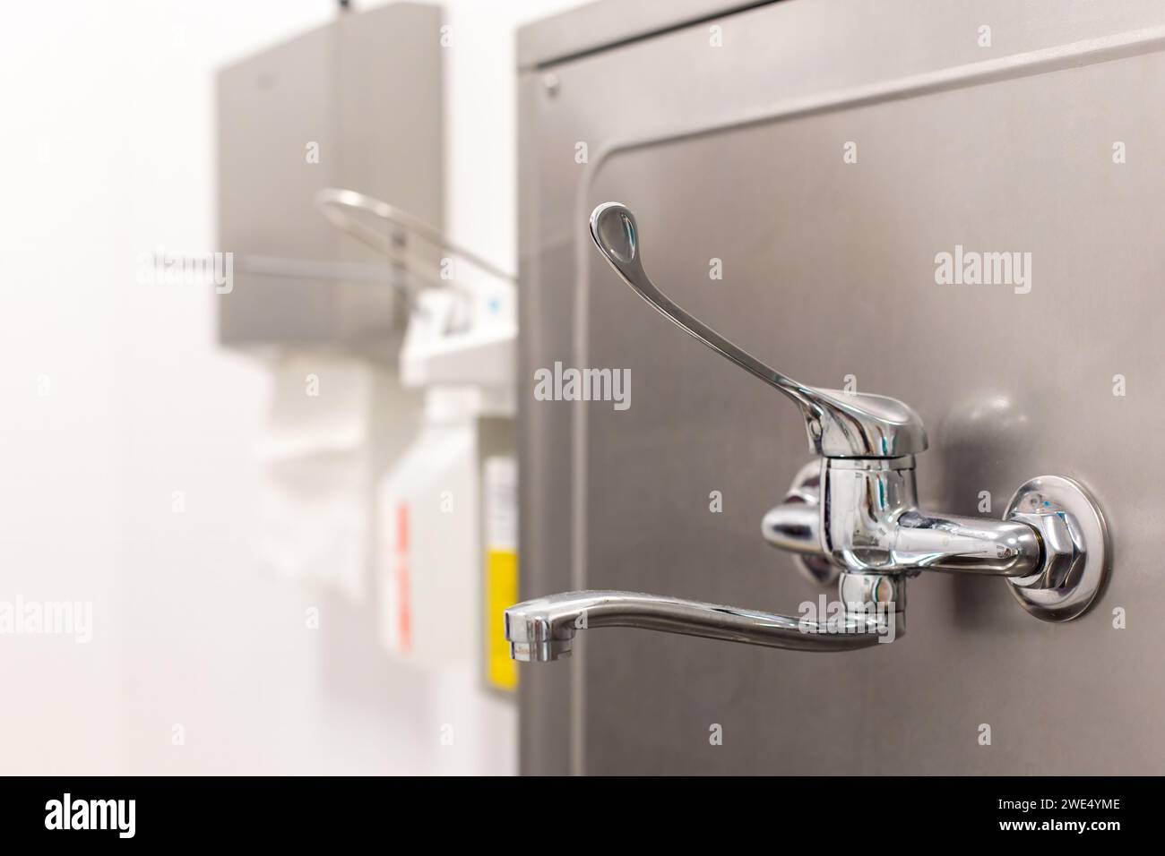 Close-up of a chrome Industrial-style public water tap in the surgery ...