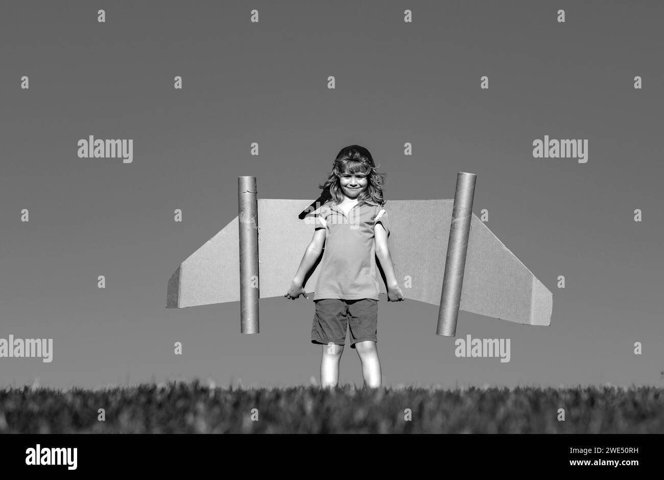 Kid with jet pack superhero. Child pilot against summer sky background ...