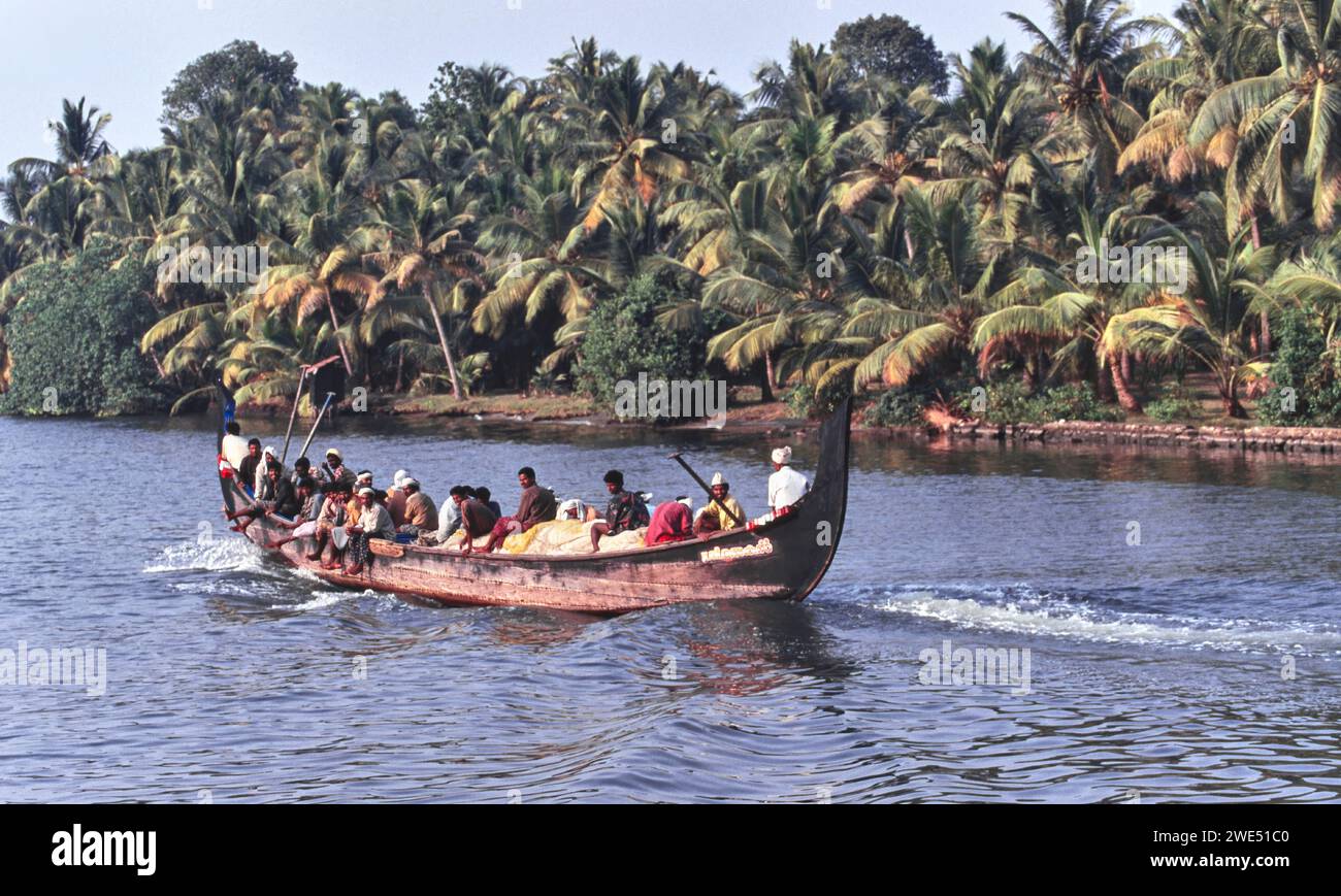 Traditional boat with passengers on a backwater canal Kerala India ...