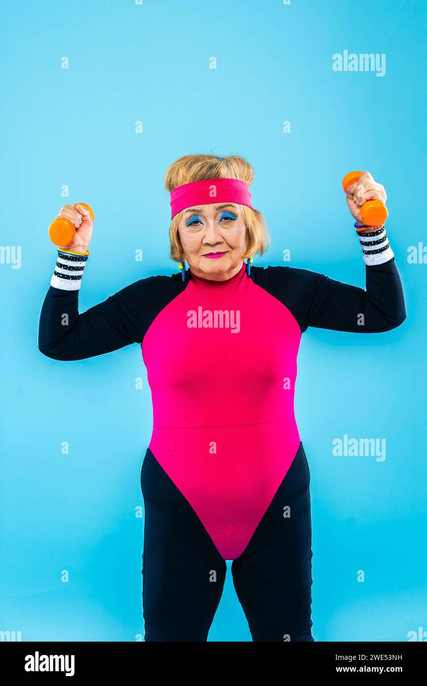 Happy and funny senior old woman wearing sportswear clothing on ...