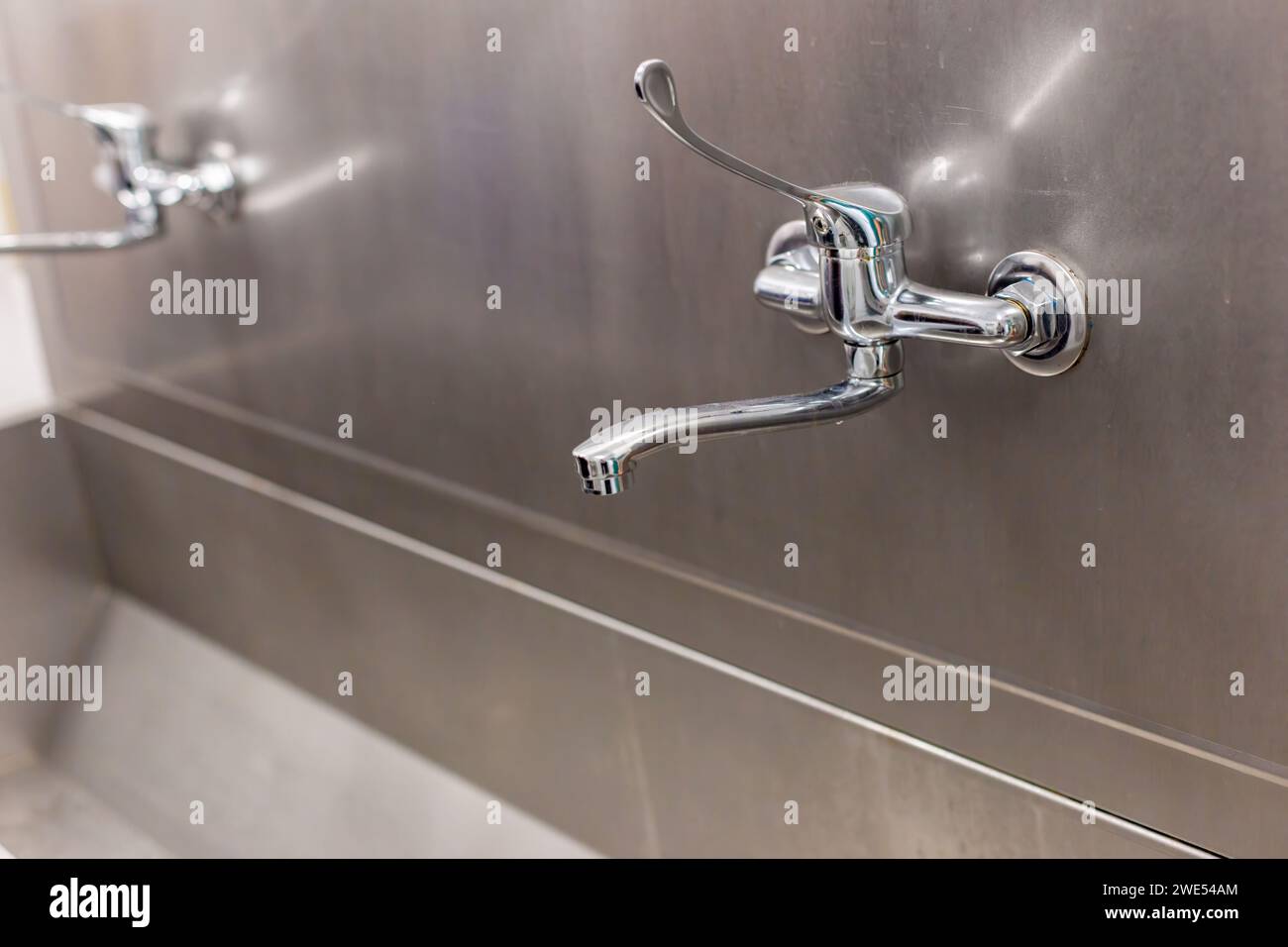 Close-up of a chrome Industrial-style public water Two taps in the ...