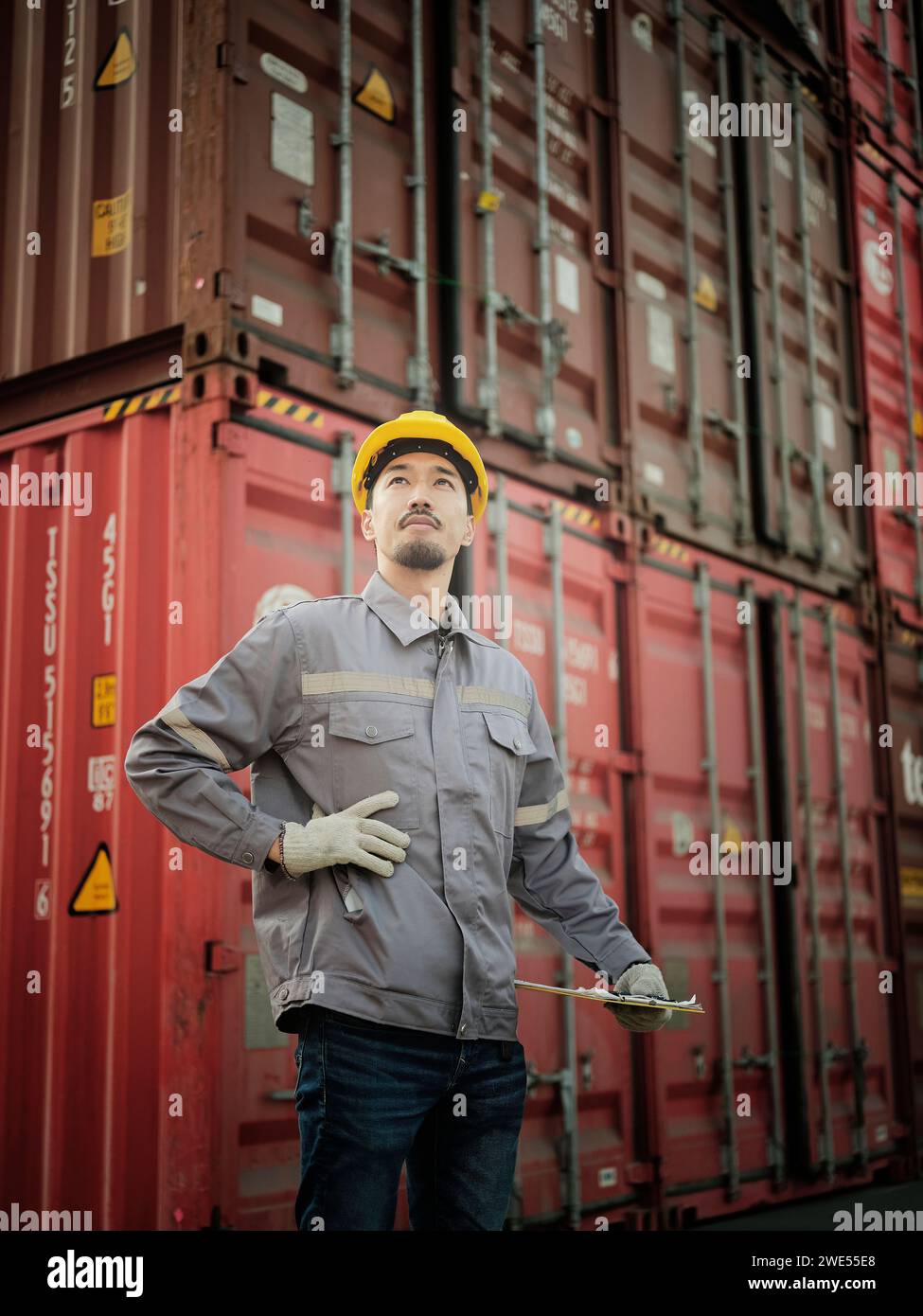 Engineer standing at container cargo yard , determined have a vision of ...