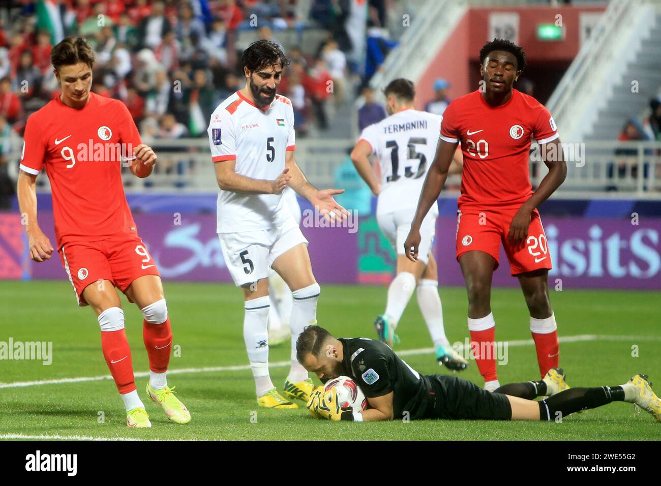 Palestine's Mohammed Saleh, center, cheers Palestine's goalkeeper Rami ...