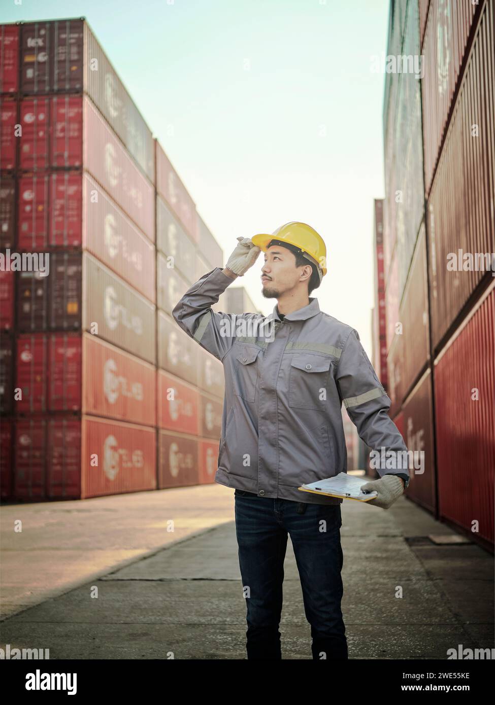 Engineer standing at container cargo yard , determined have a vision of ...