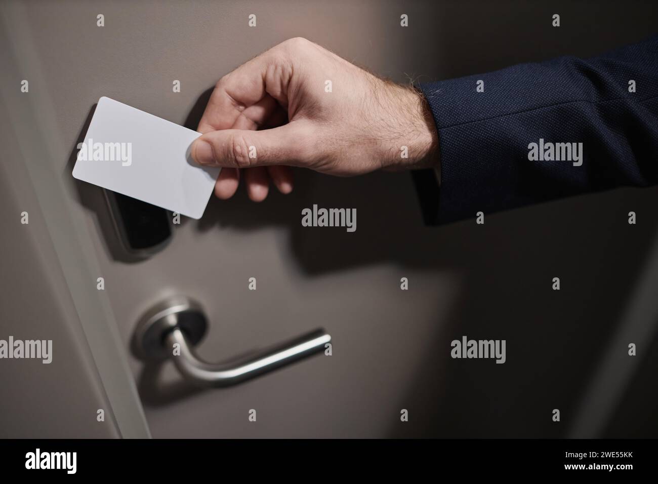 Close up of unrecognizable businessman opening hotel room door with ...