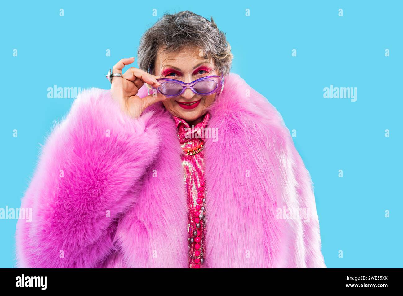 Happy and funny senior old woman wearing fashinable clothing on ...