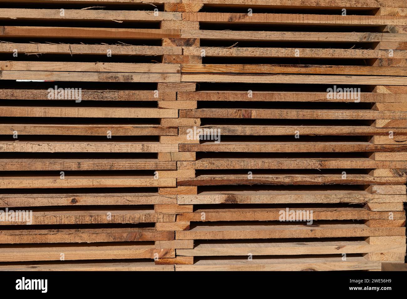 Treated timber packed in blocks. Wooden timber in the sawmill. Stacked ...