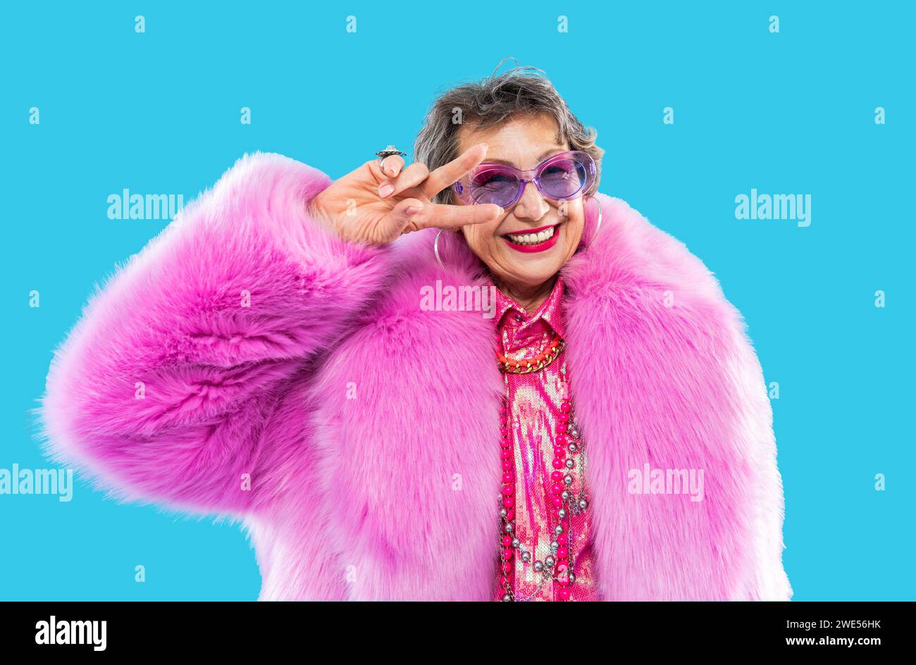 Happy and funny senior old woman wearing fashinable clothing on ...