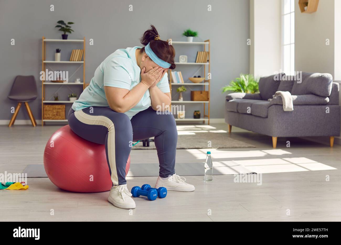Fat woman who can't lose weight despite sports workouts is sitting on ...