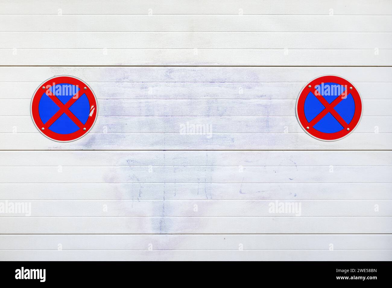 White garage door with no parking and no stopping traffic sign, copy ...