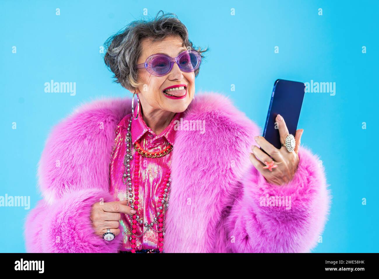 Happy and funny senior old woman wearing fashinable clothing on ...