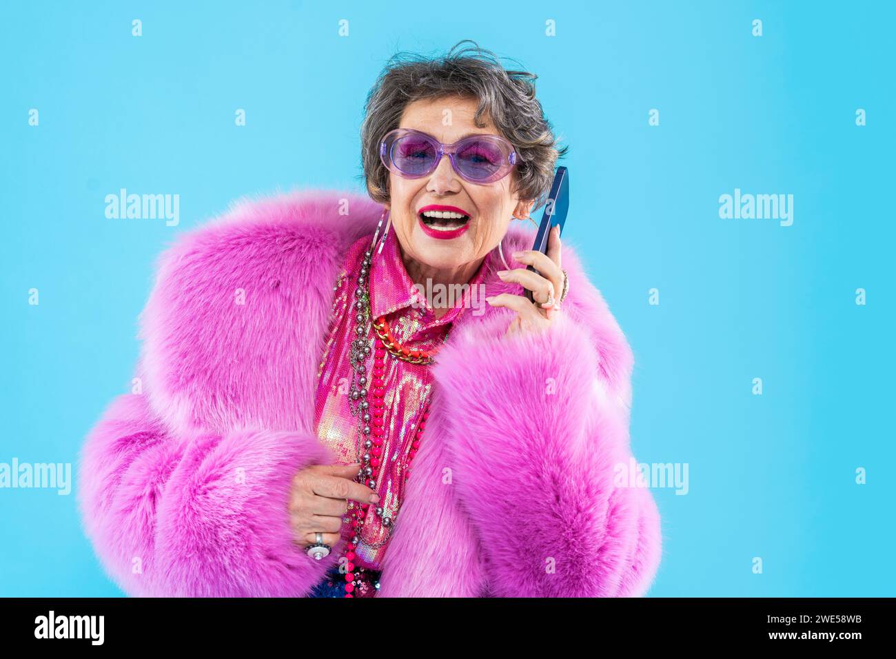 Happy and funny senior old woman wearing fashinable clothing on ...