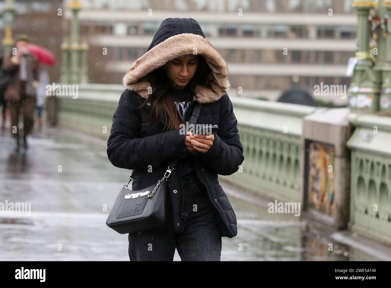 London, UK. 23rd Jan, 2024. A woman seen using her mobile phone in ...