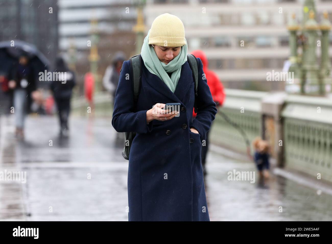 London, UK. 23rd Jan, 2024. A woman seen using her mobile phone in ...
