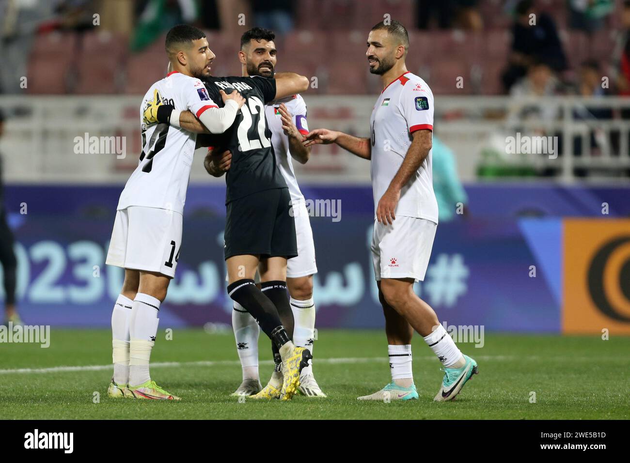 Palestine's goalkeeper Rami Hamada, , center, is embraced by teammates ...
