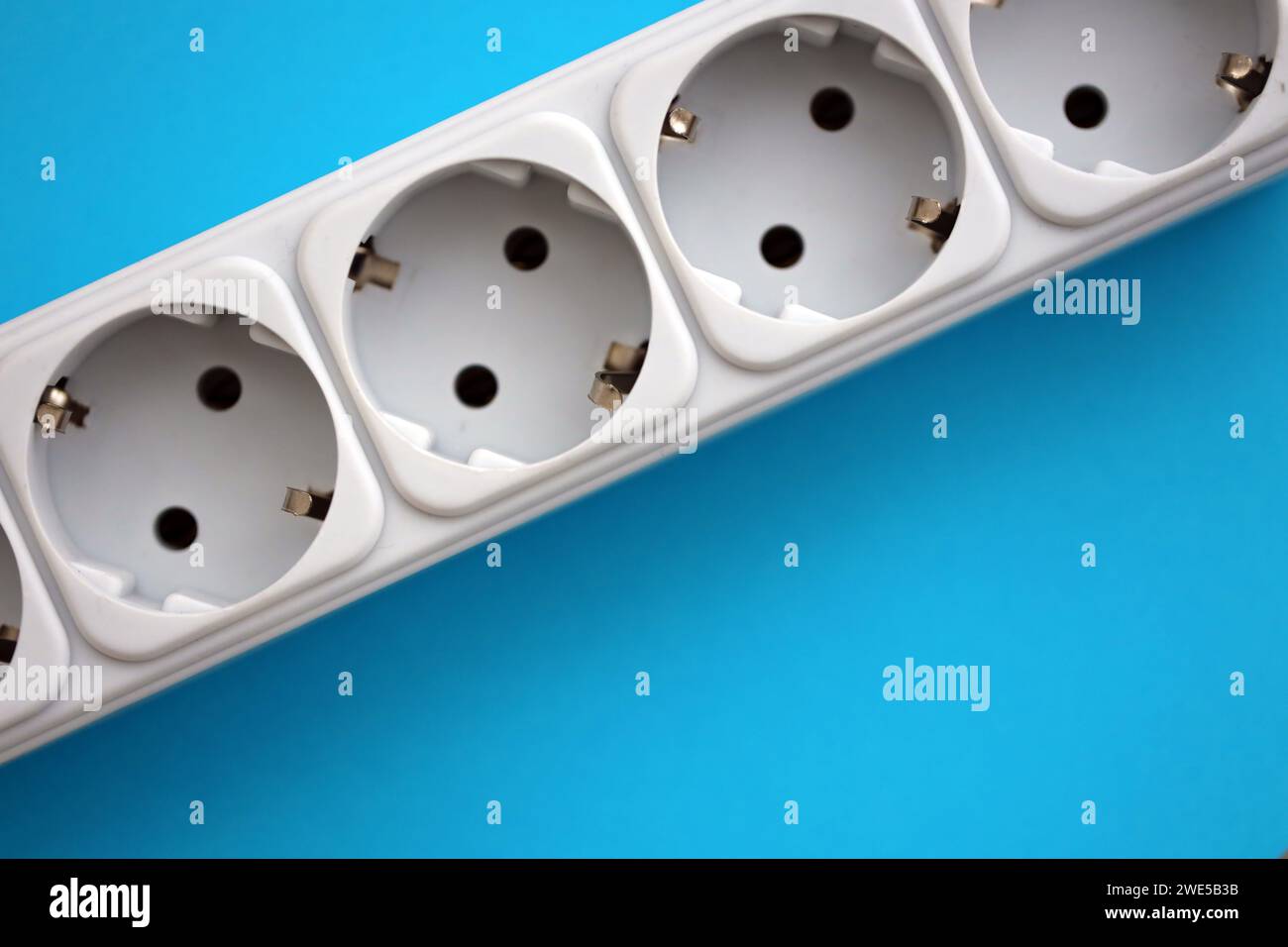 White electrical multi plug extender with european socket on bright ...