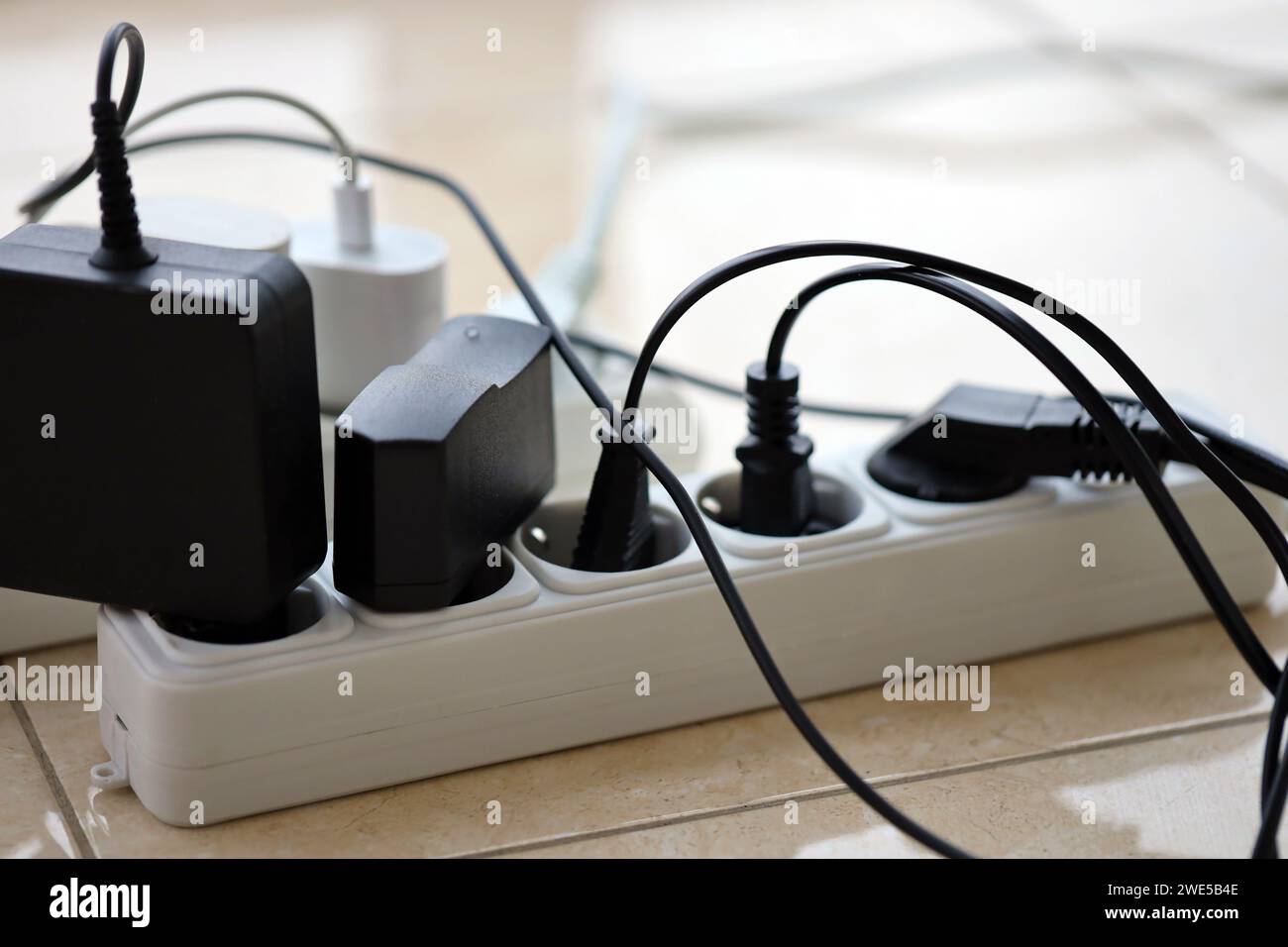 Overloaded power boards. Power strips with different electrical plugs ...