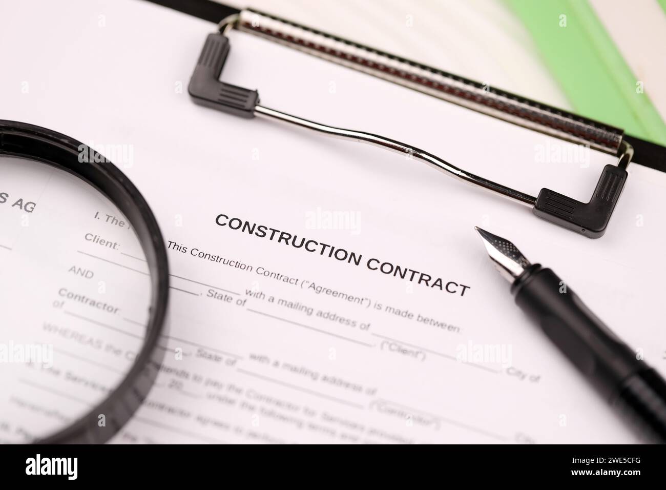 Construction contract form on A4 tablet lies on office table with pen ...