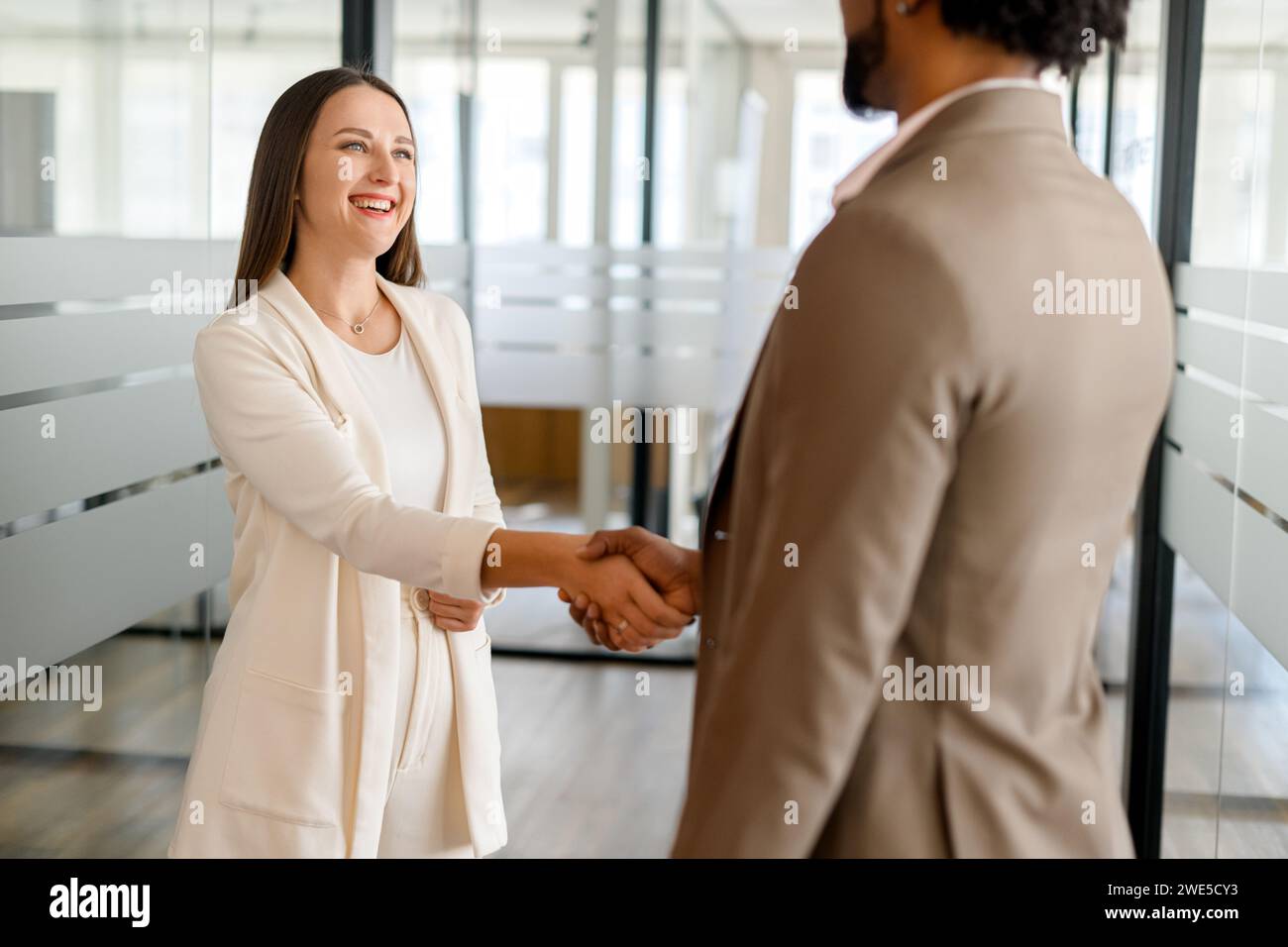 A warm handshake between an African-American businessman and his ...