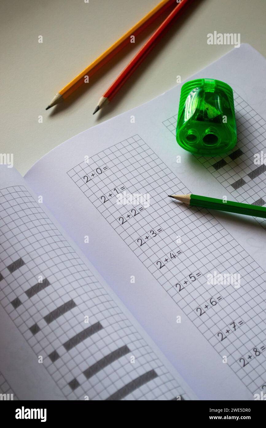 learning to count and write numbers correctly, notebook and pencils ...