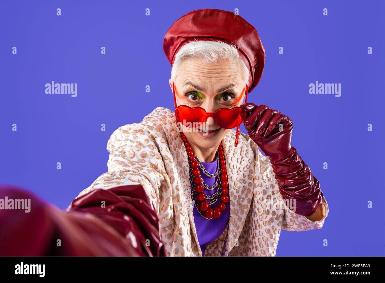 Happy and funny senior old woman wearing fashinable clothing on ...