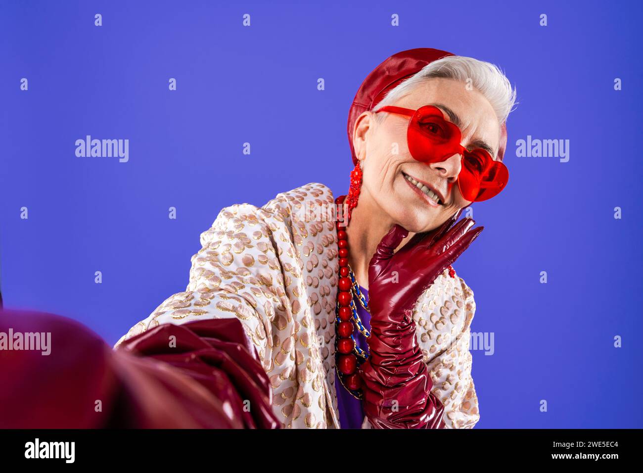 Happy and funny senior old woman wearing fashinable clothing on ...