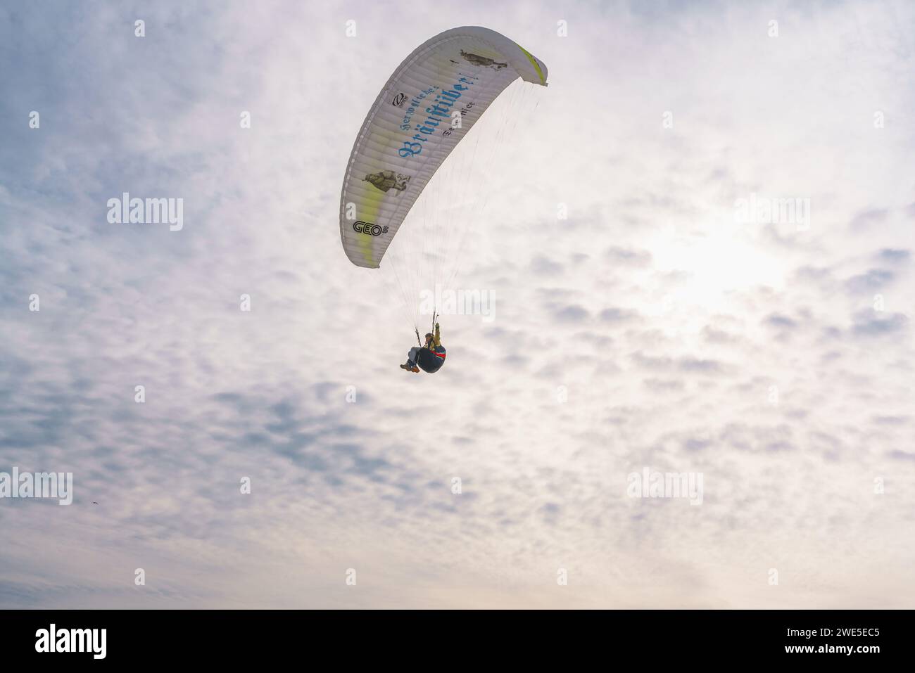 Person is gliding through the sky with a colorful parachute, enjoying ...