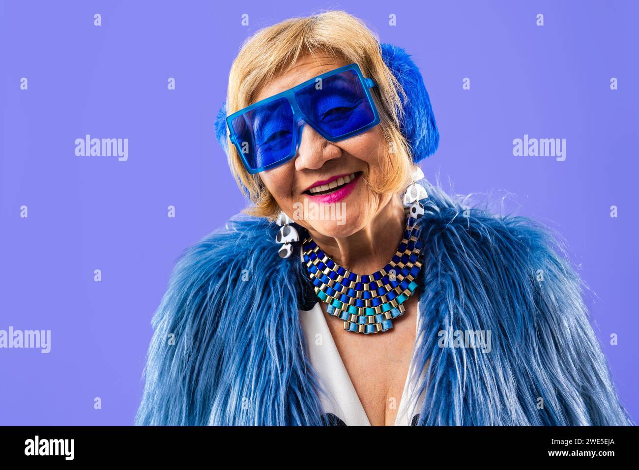 Happy and funny senior old woman wearing fashinable clothing on ...