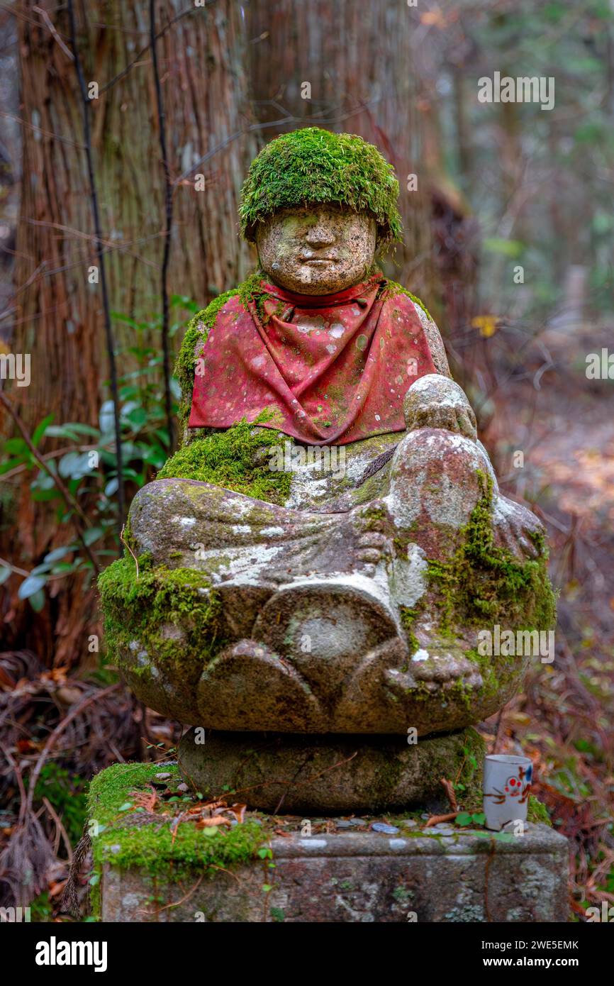 statue with commemorative stone hat inside the Okunoin Koyasan cemetery ...