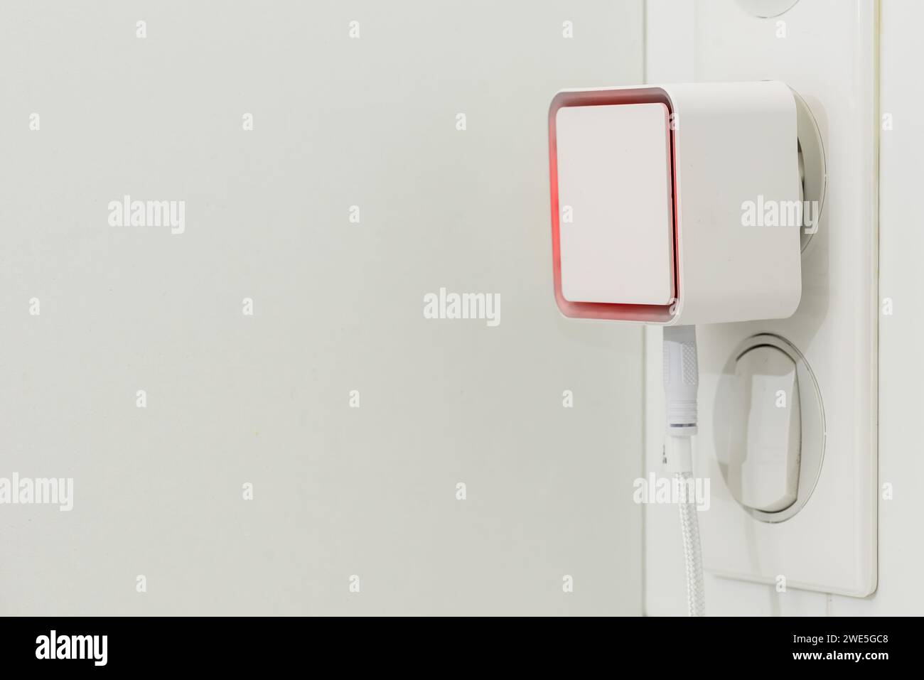 Smart water guard with red alarm turned on against white background ...
